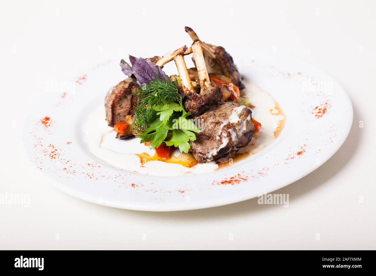 Grilled rack of lamb with cheese sauce and vegetable garnish Stock ...