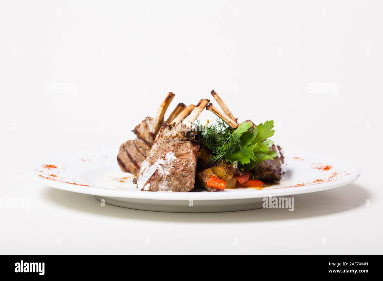 Grilled rack of lamb with cheese sauce and vegetable garnish Stock ...