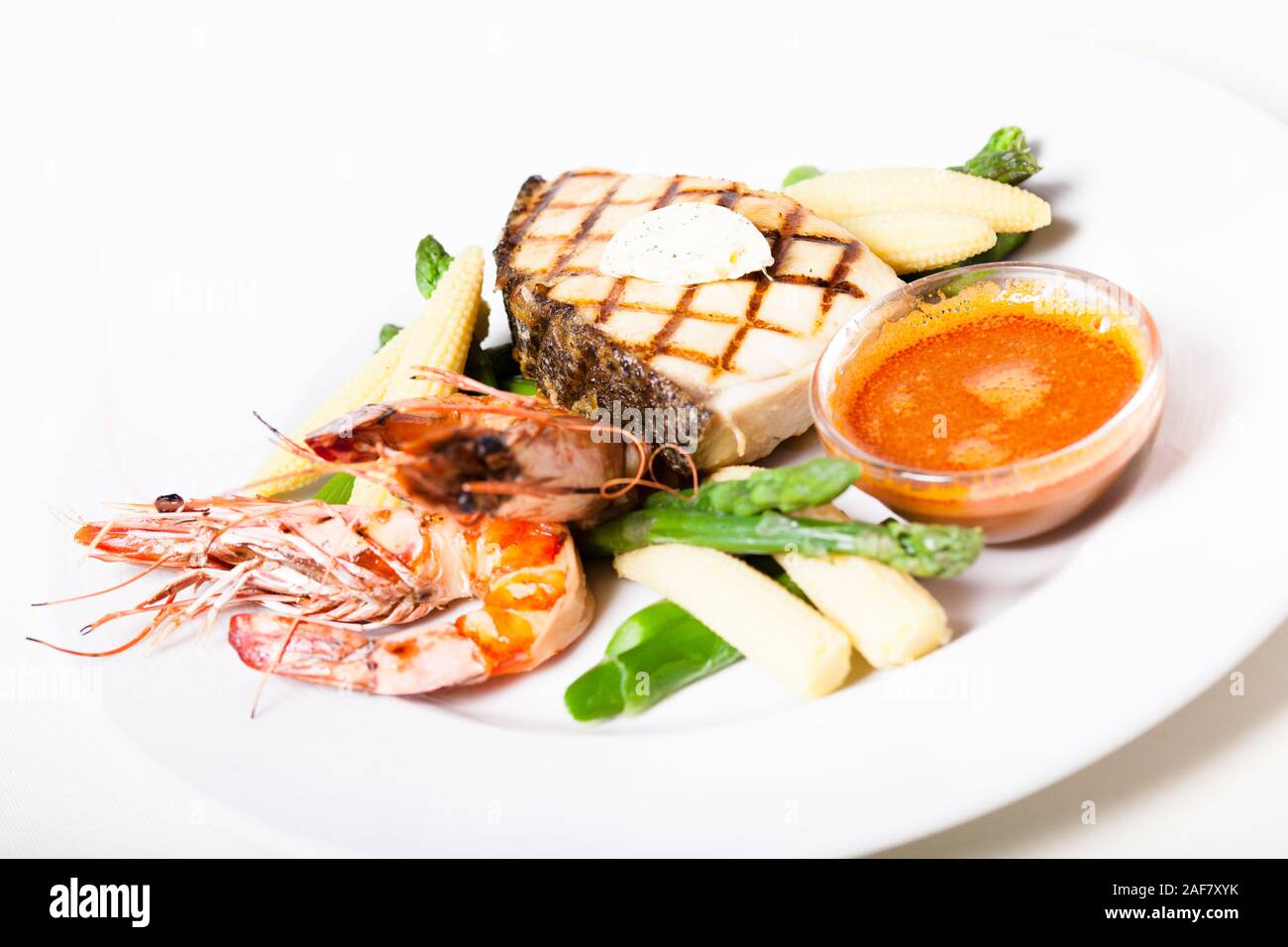 Grilled fish steak wit prawns and vegetables Stock Photo - Alamy