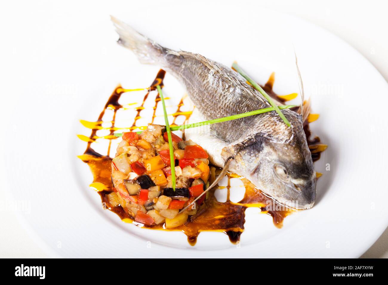Baked dorado fish with vegetables Stock Photo - Alamy