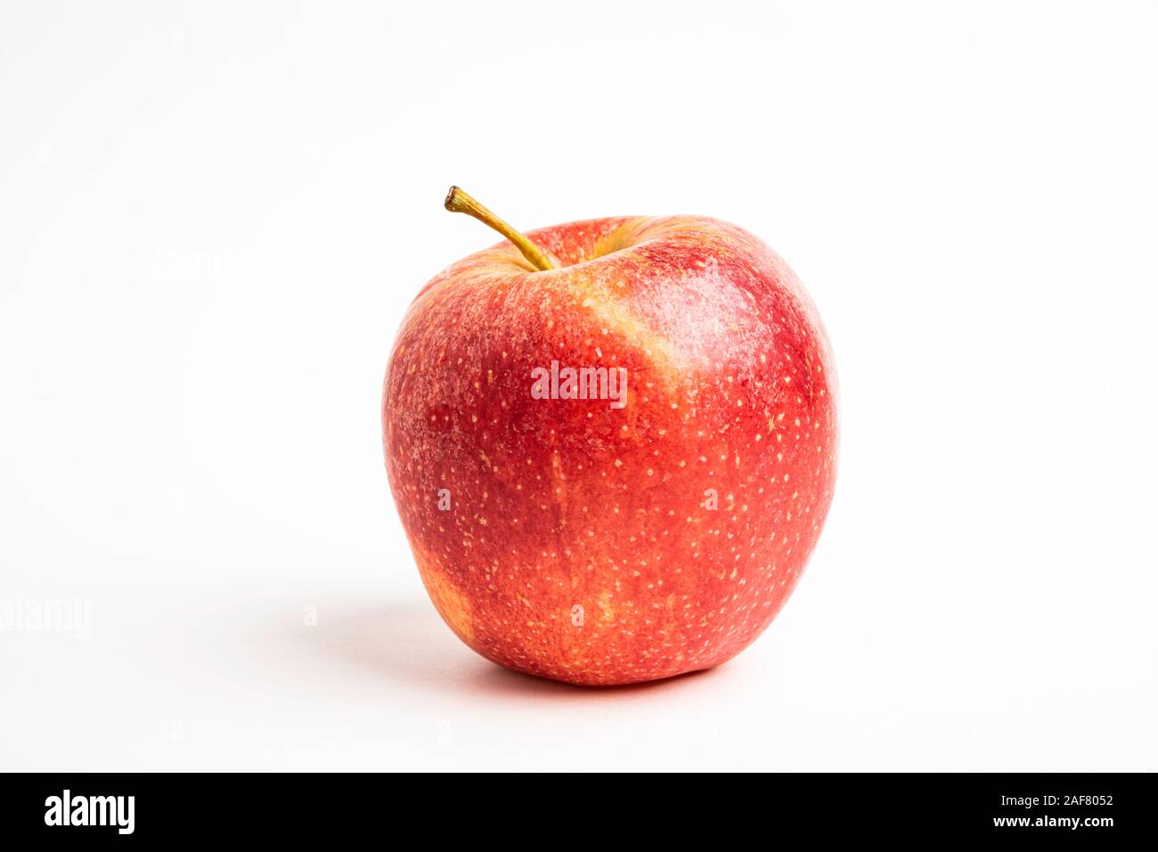 One fresh red apple isolated on a plain white background Stock Photo ...
