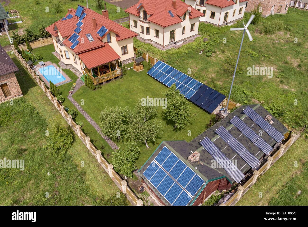 Aerial view of a residential private house with solar panels on roof ...