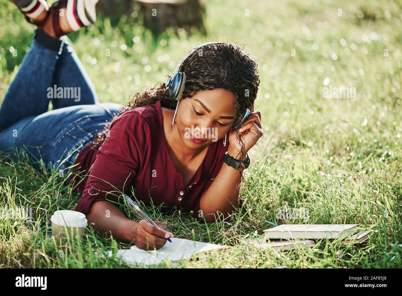 In the park at summertime. Cheerful african american woman Stock Photo ...
