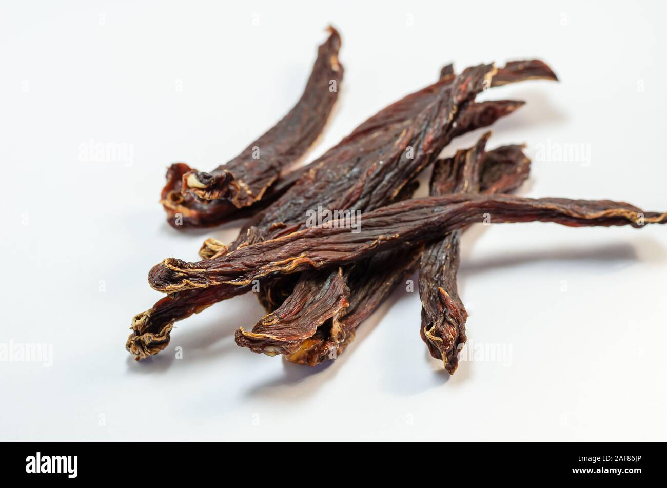 Slices of beef jerky on a light background. Close-up of healthy and ...
