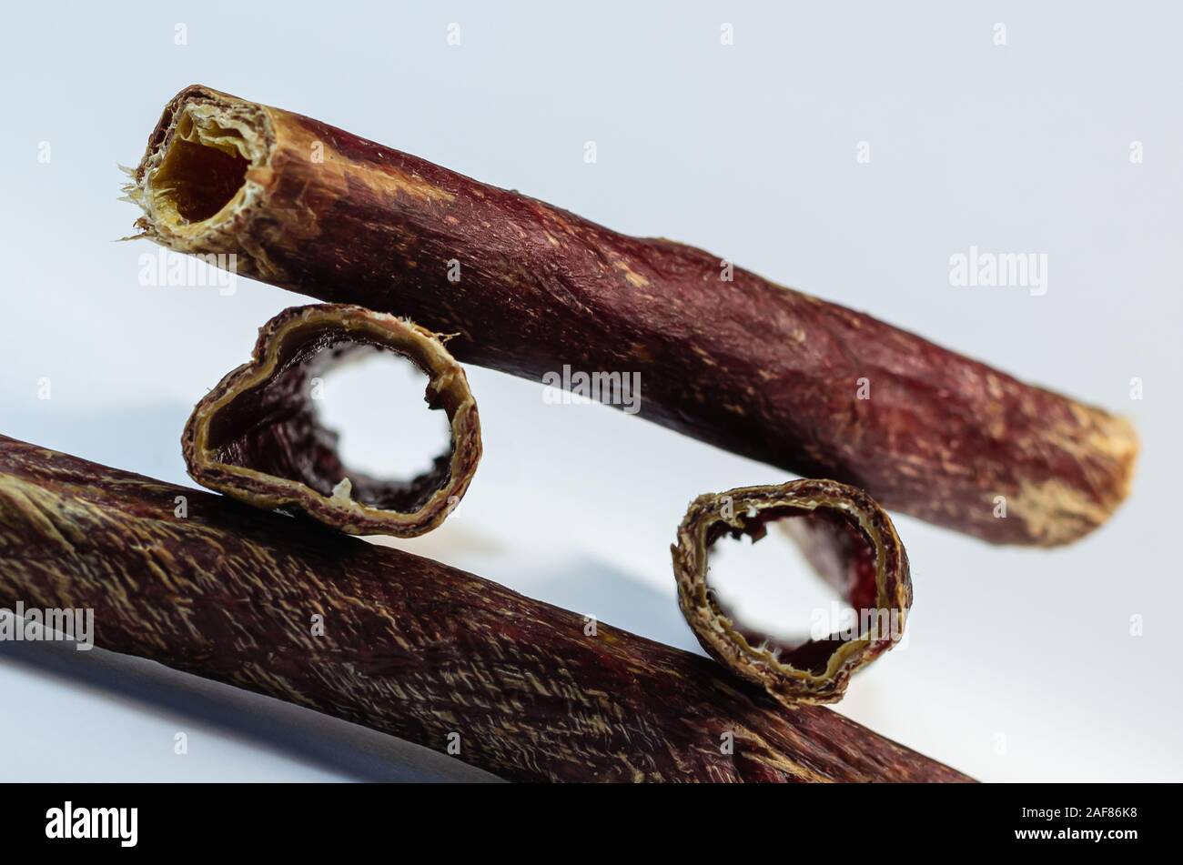 Dried beef esophagus. Natural treats for pets on a light background ...