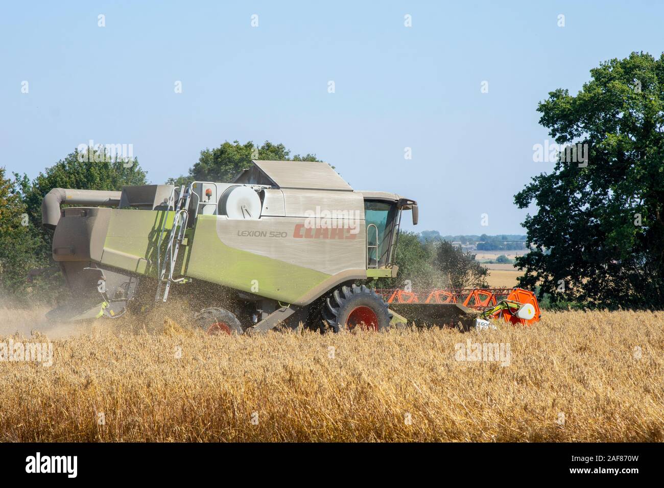 Combine harvester combining oats Stock Photo - Alamy