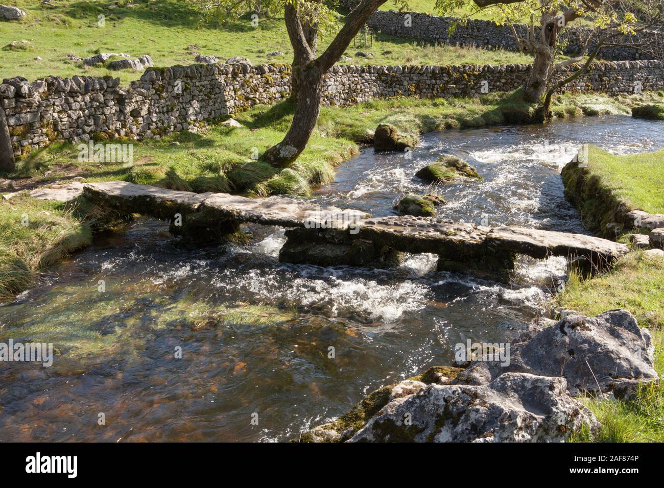 A small footbridge over a stream below Malham Cove in Yorkshire Dales ...