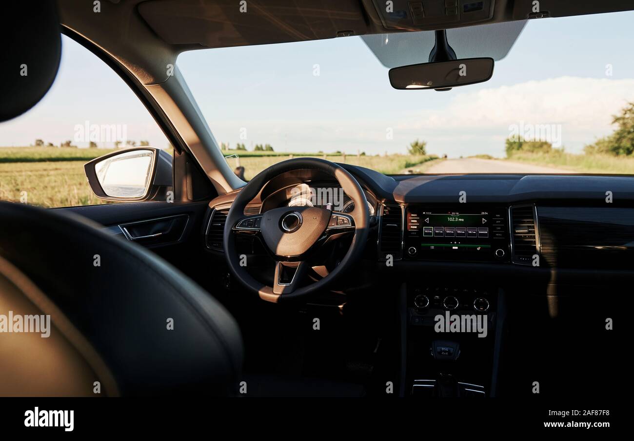 At countryside. Inside modern car. Front panel, steering wheel, quality ...