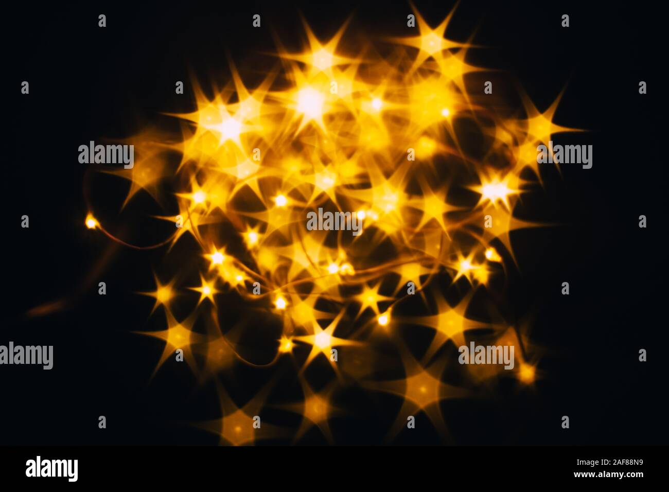 Splash of golden stars on black background Stock Photo - Alamy