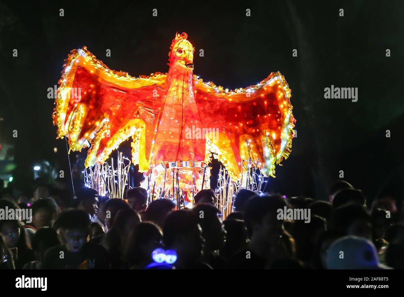 Quezon, Philippines. 13th Dec, 2019. Students march with a parade float ...