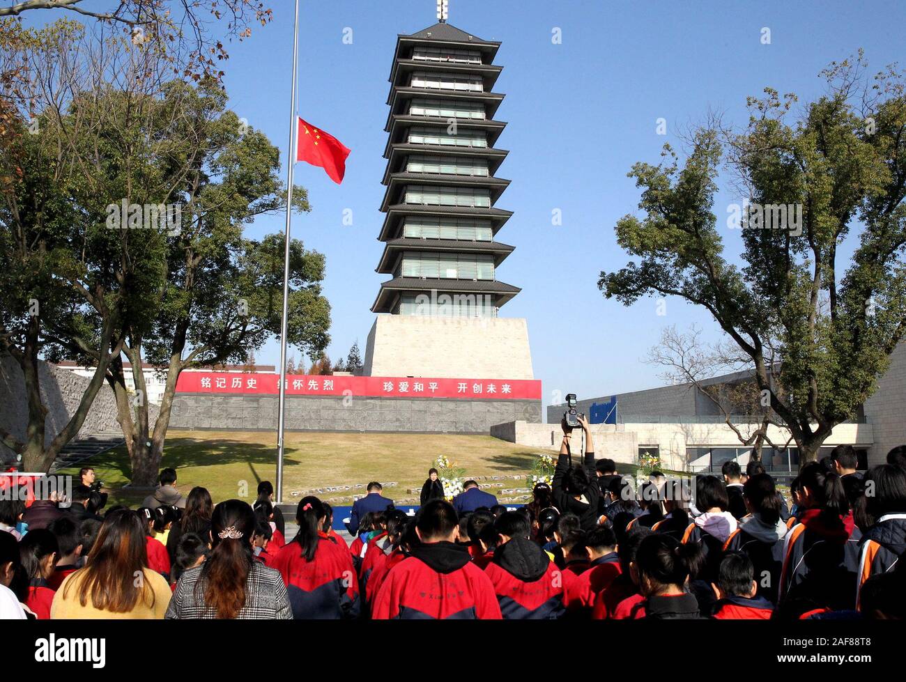 Shanghai, China. 13th Dec, 2019. People mourn the victims during a ...
