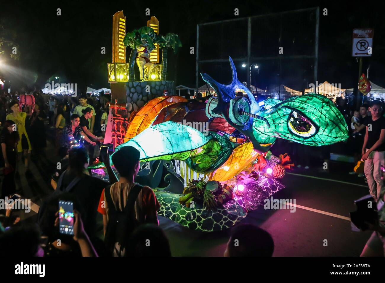 Quezon, Philippines. 13th Dec, 2019. Students march with a parade float ...
