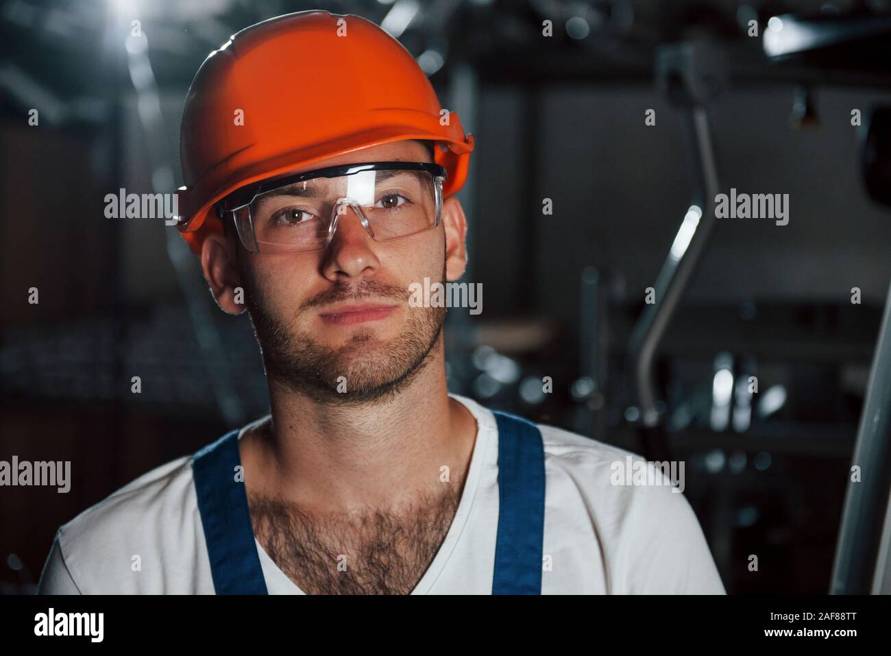 At workplace. Portrait of engineer in metallurgical factory in ...