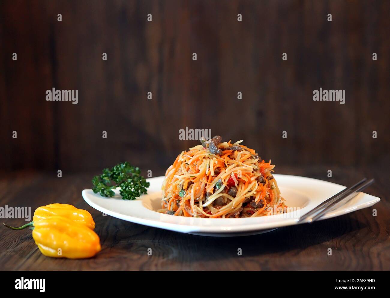 Spicy Korean-style carrot salad on a dark background. Koryo-saram ...