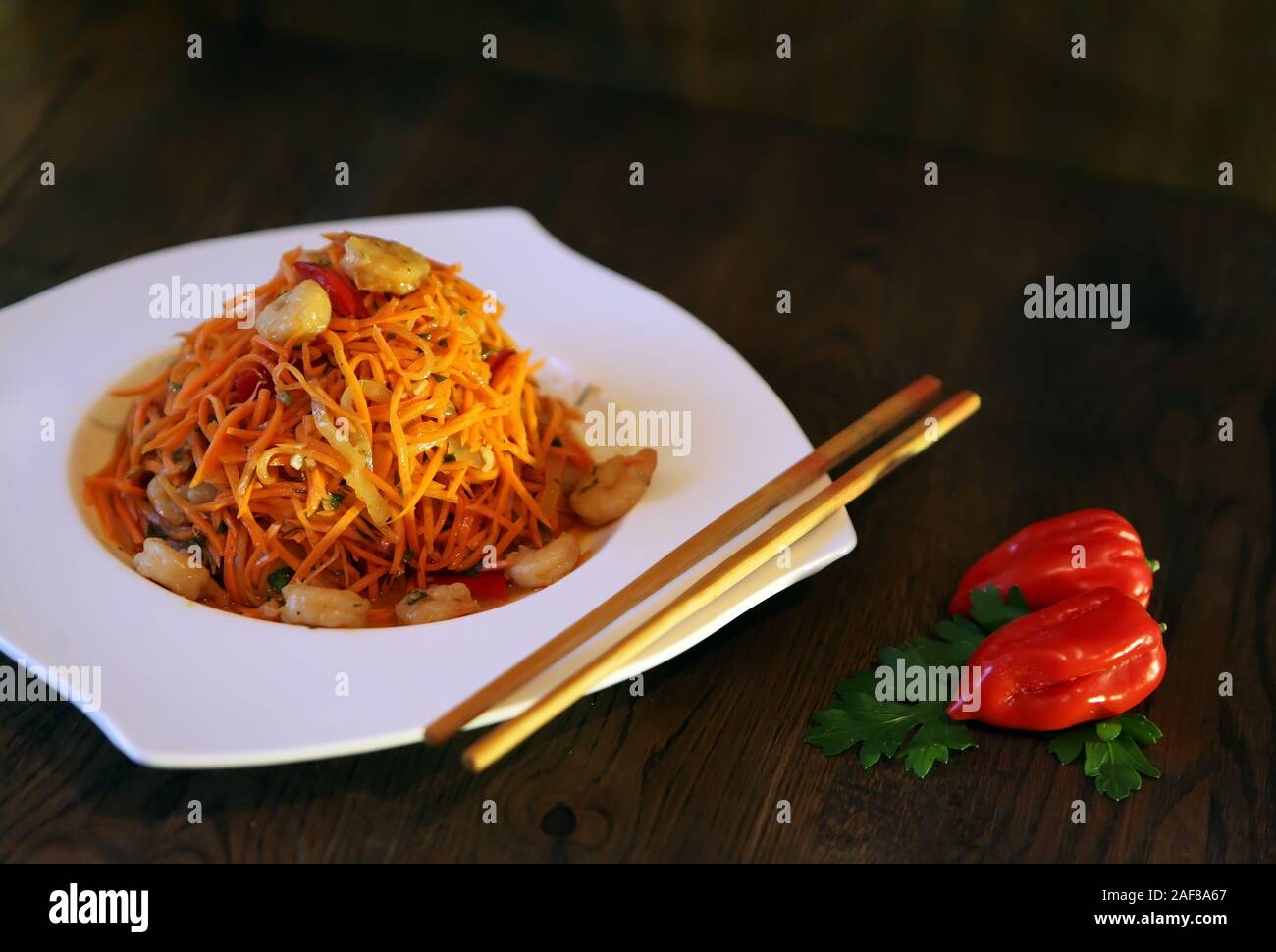 Spicy Korean-style carrot salad on a dark background. Koryo-saram ...