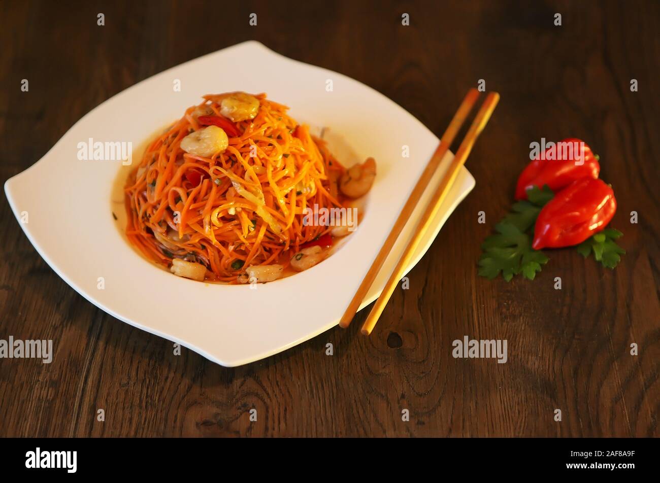 Spicy Korean-style carrot salad on a dark background. Koryo-saram ...