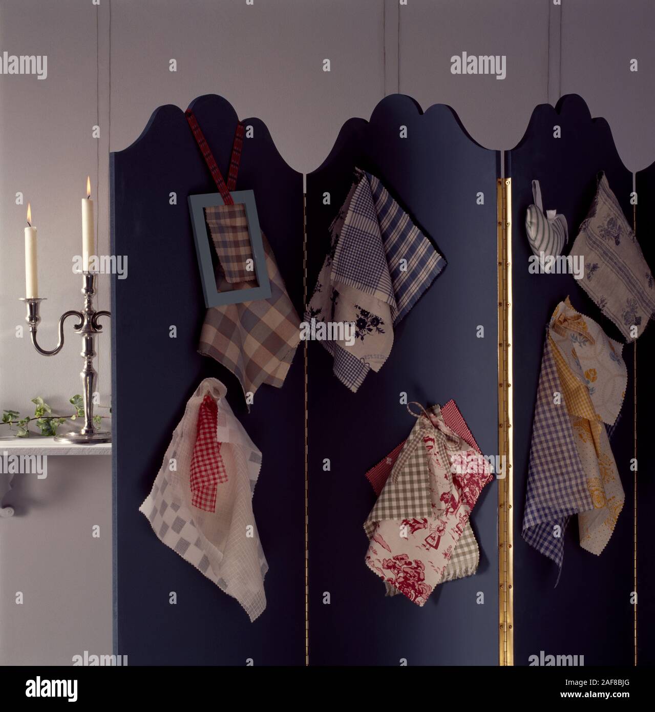 Screen used to display swatches of fabric in workroom Stock Photo - Alamy