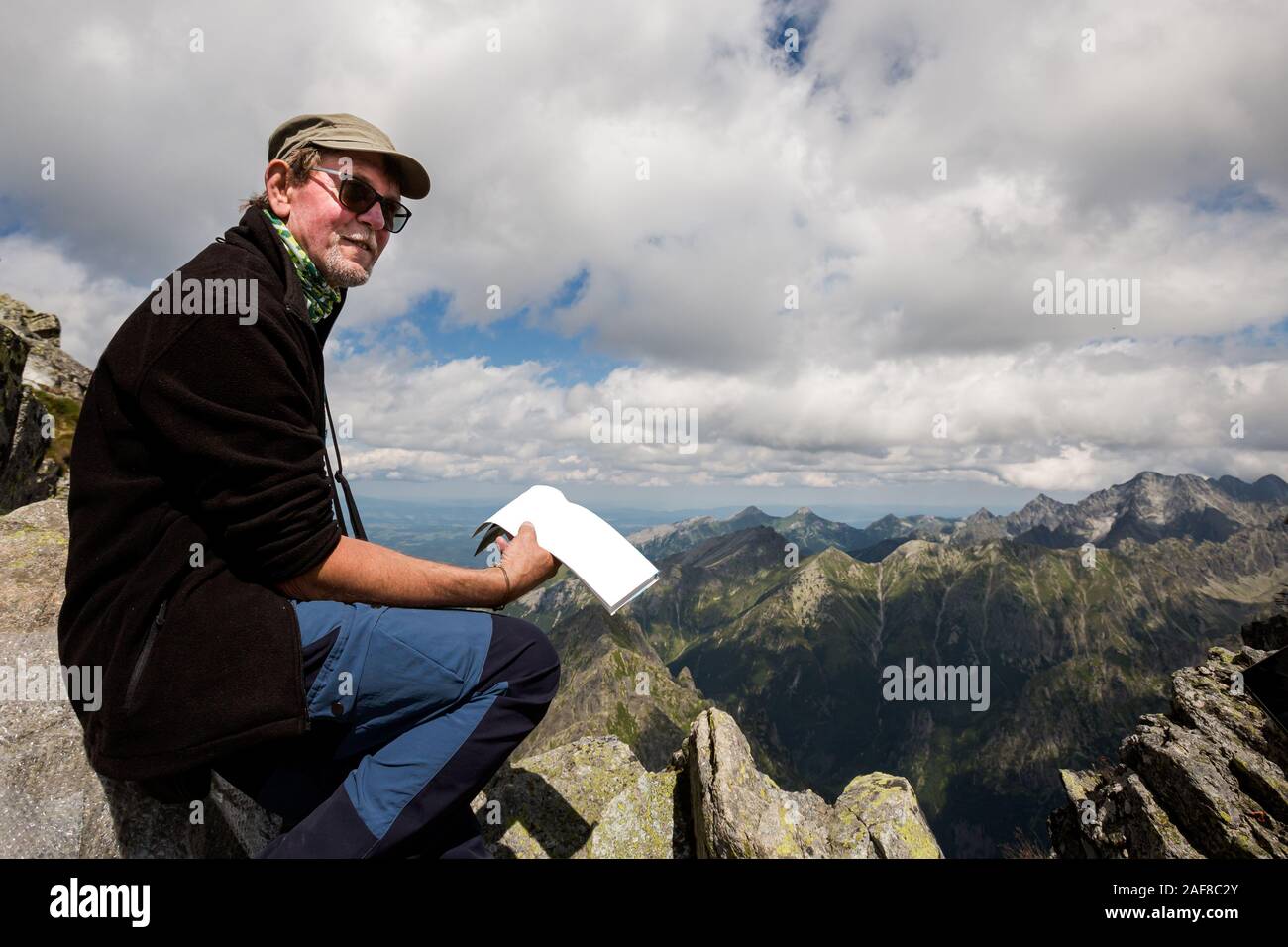 Tourist with a map on Rysy highest peak of Poland. Path from Slovakia ...