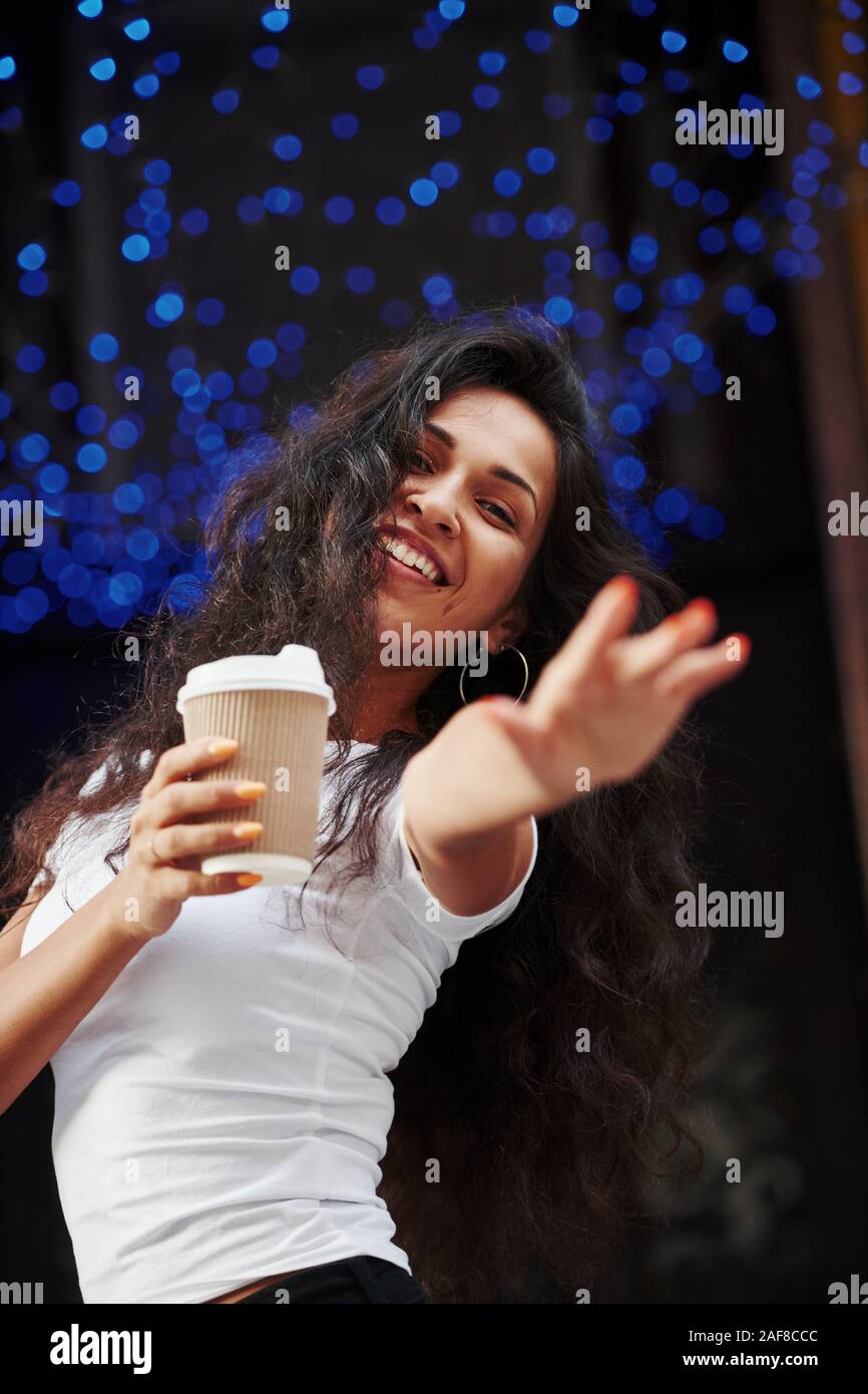 Trying to reach you by the hand. Beautiful woman with curly black hair ...