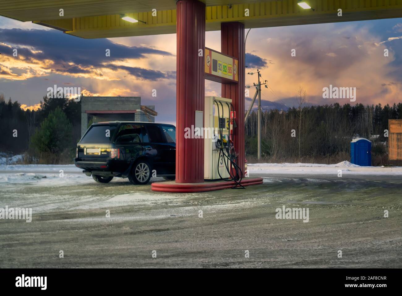 Gas station at sunset. Gas station. Petrol pump in gas station. Filling ...