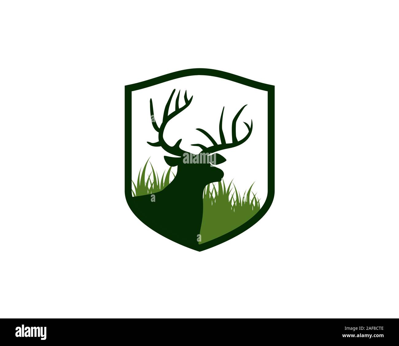 deer head with antlers in front of meadow grass inside crest shield ...