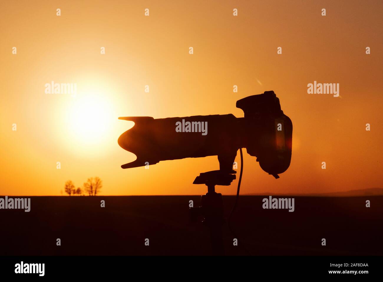 Side view of camera on tripod. Beautiful landscape with field ...