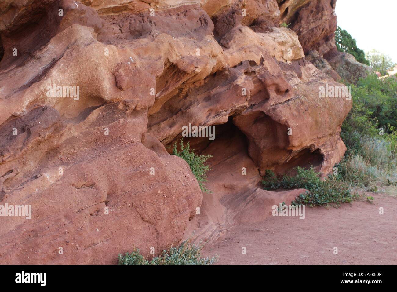 A large red sandstone formation showing signs of erosion on the Trading ...