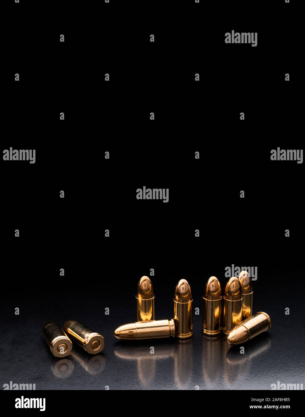 Bullet isolated on black background with reflexion. Rifle bullets close ...
