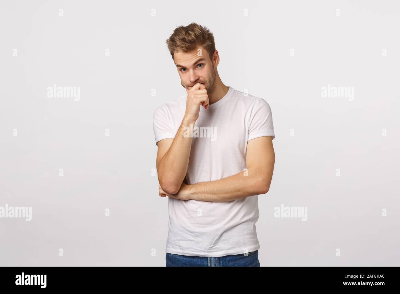 Troubled and shocked, indecisive blond handsome boyfriend, dont know ...