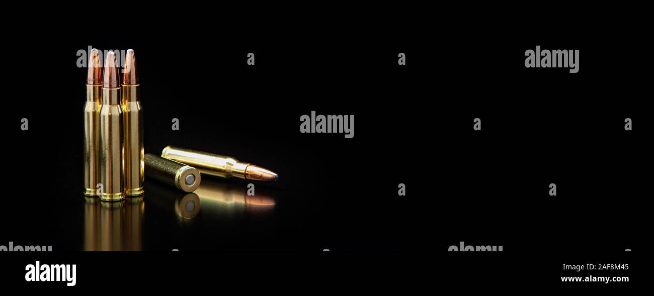 Bullet isolated on black background with reflexion. Rifle bullets close ...