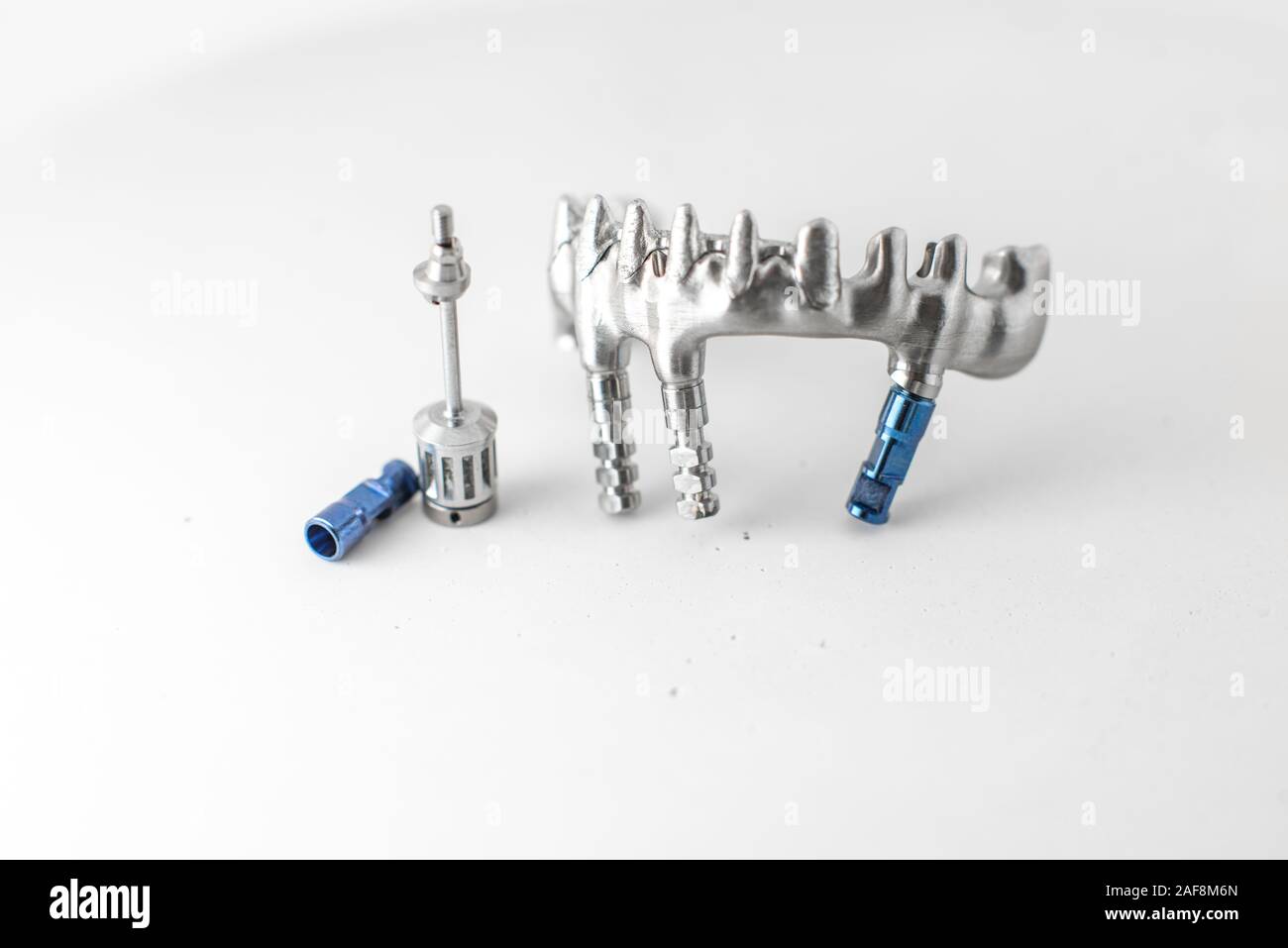 Close-up studio shot on milled metal frame for dental implants on the ...