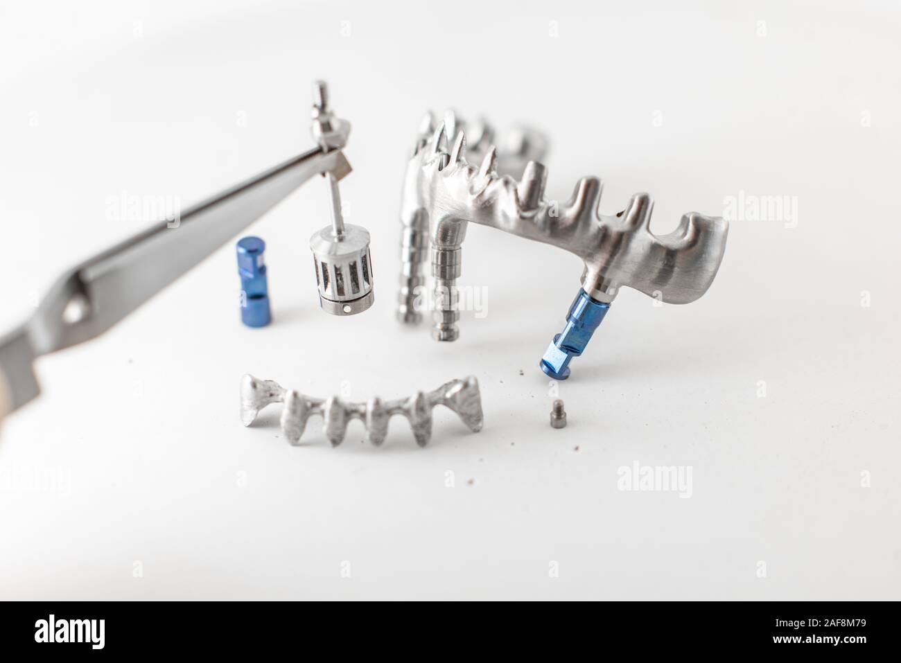 Close-up studio shot on milled metal frame for dental implants on the ...