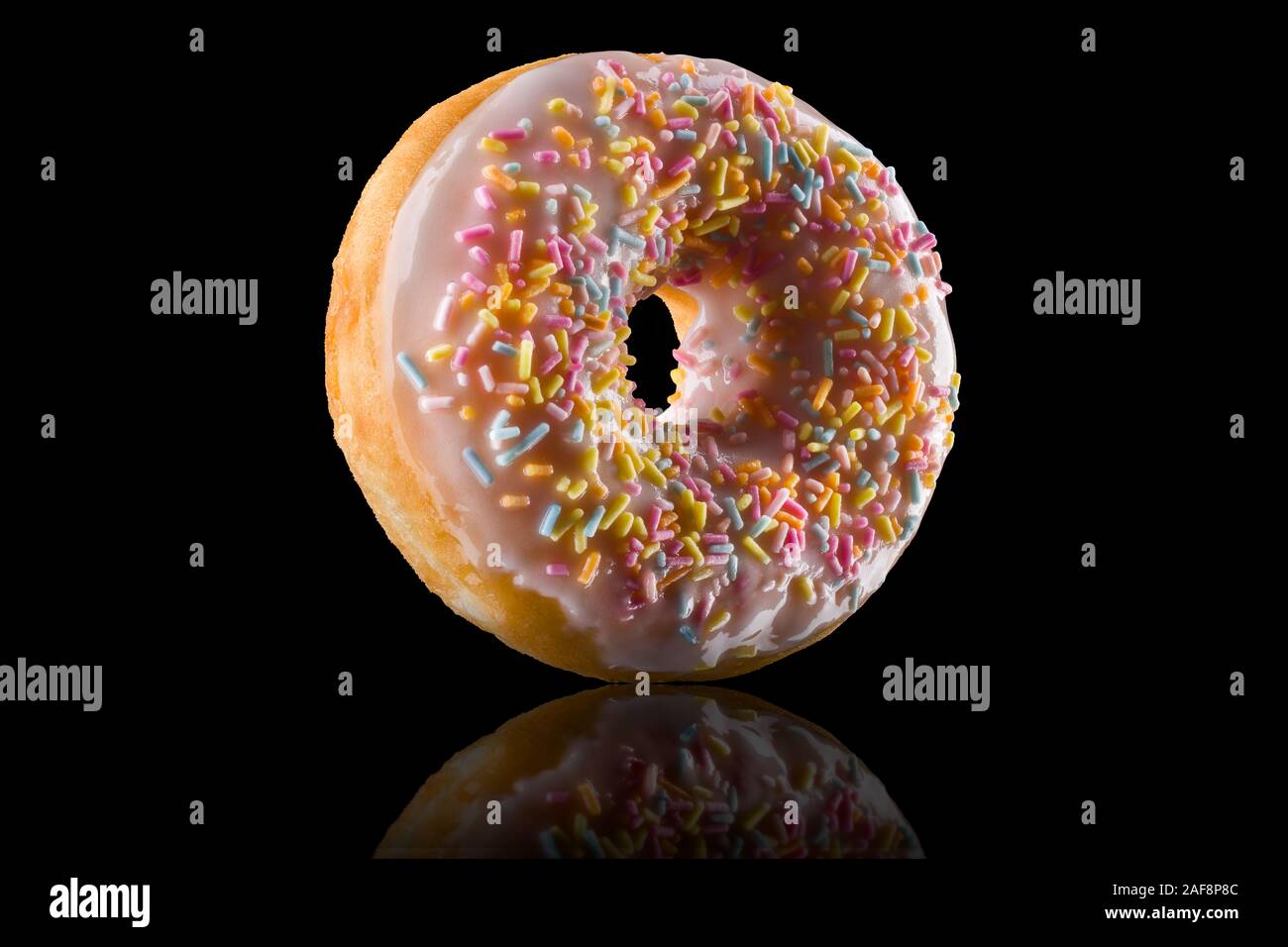 Glazed donut with reflection and clipping path on a black background ...