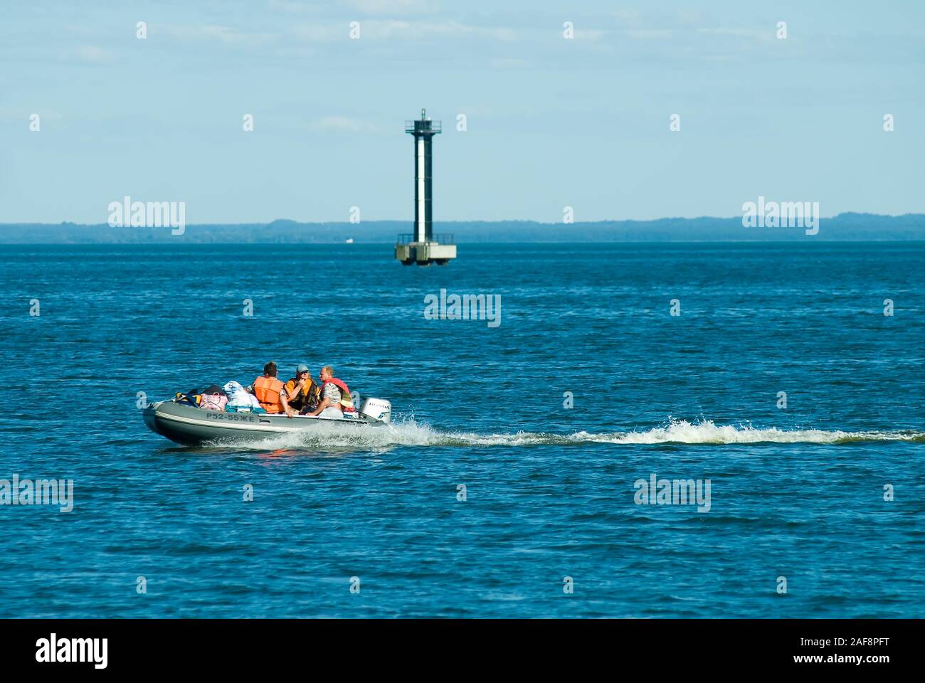People in rubber boat with motor float Stock Photo - Alamy