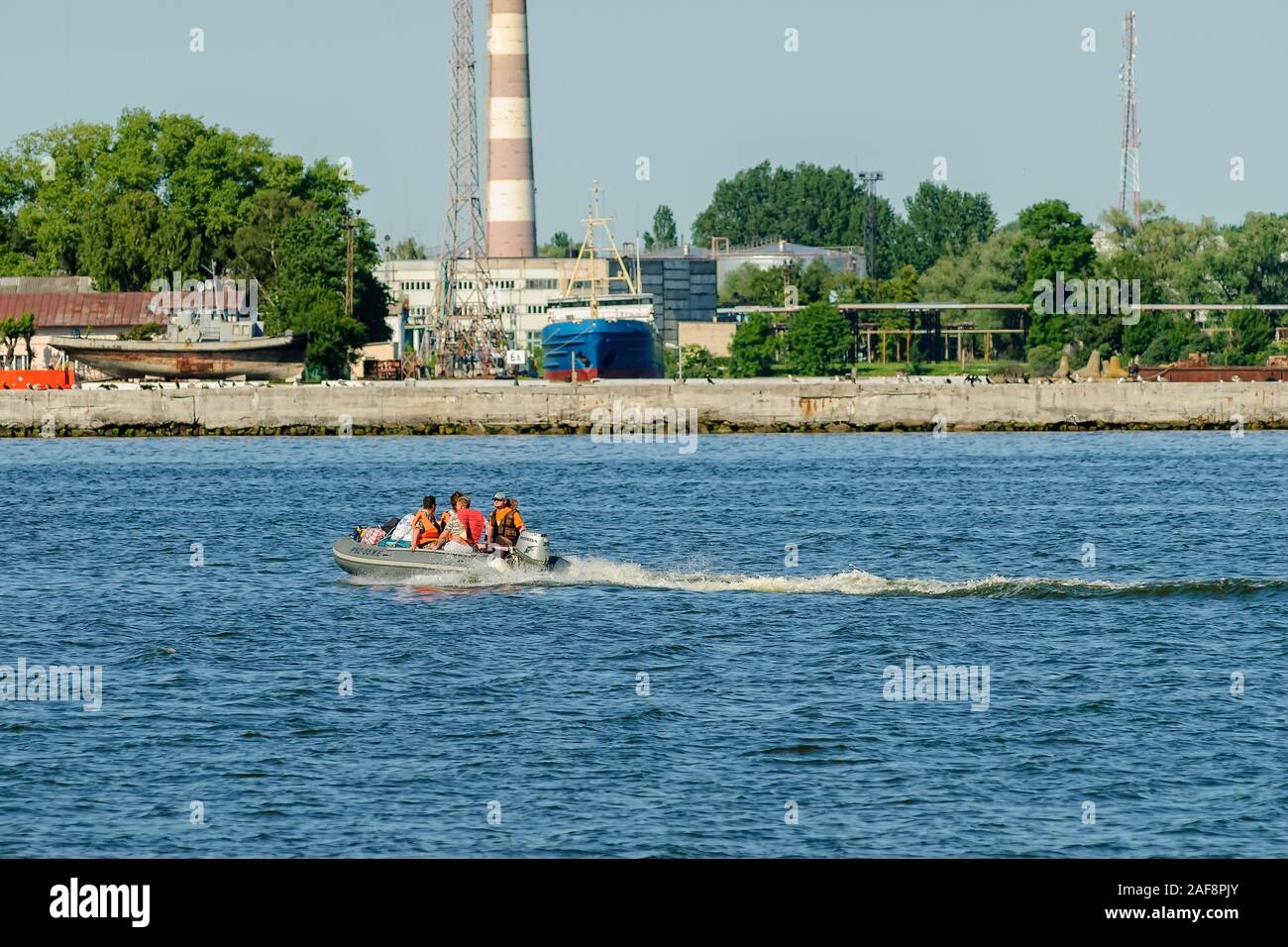 People in rubber boat with motor float Stock Photo - Alamy