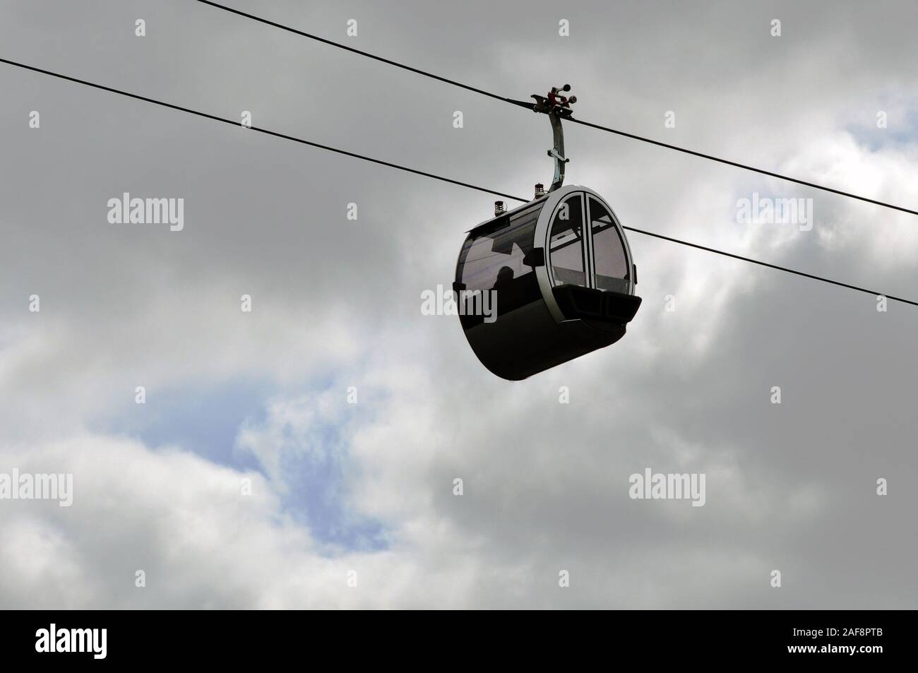 Cable car on a background of cloudy dark sky. Urban transport Stock ...