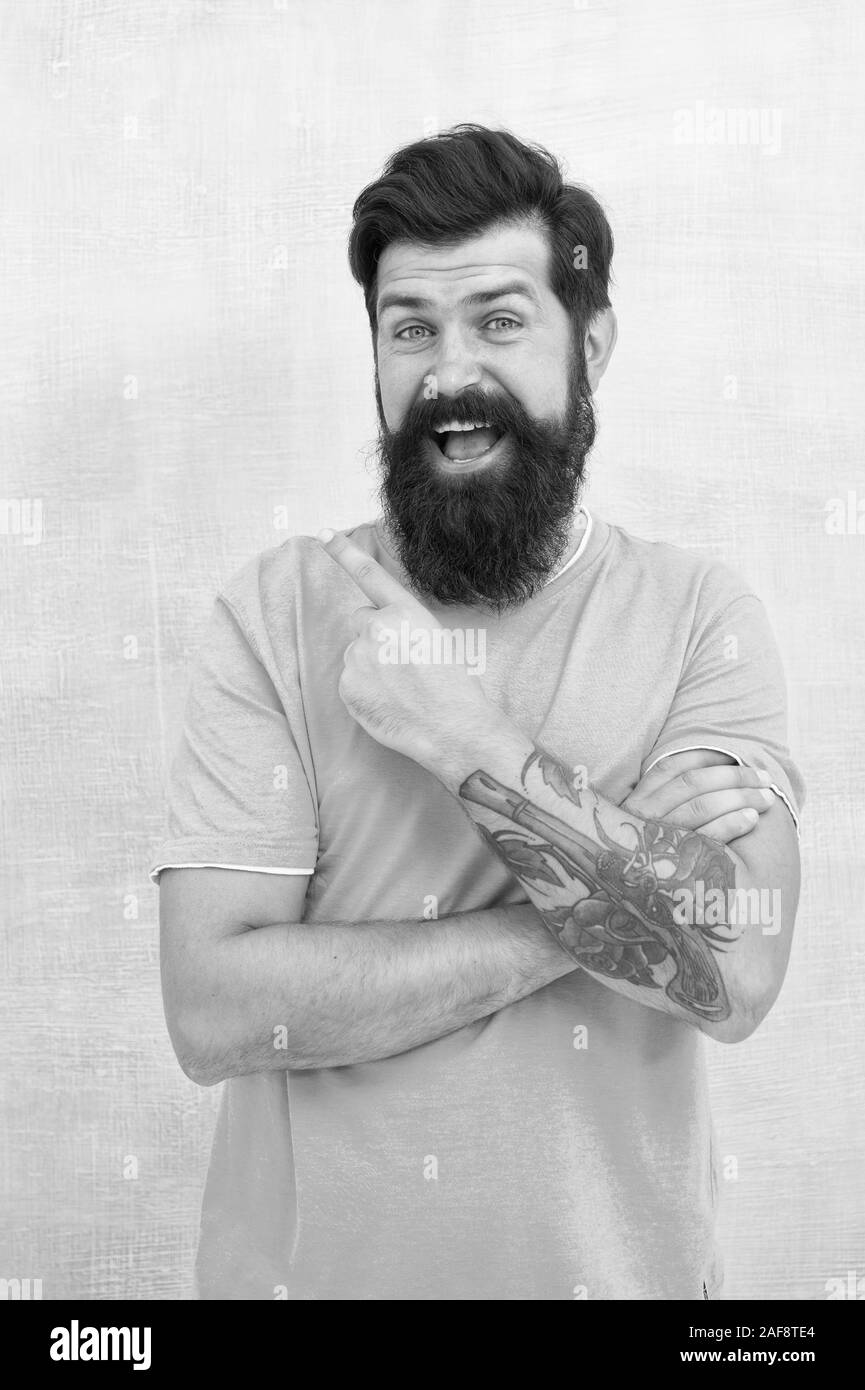 Look there. Bearded man pointing up isolated on white. Happy hipster ...