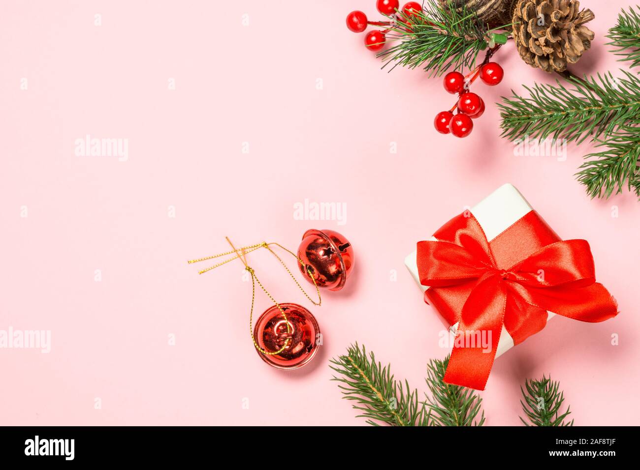 Christmas present box with jingle bells on pink background Stock Photo ...