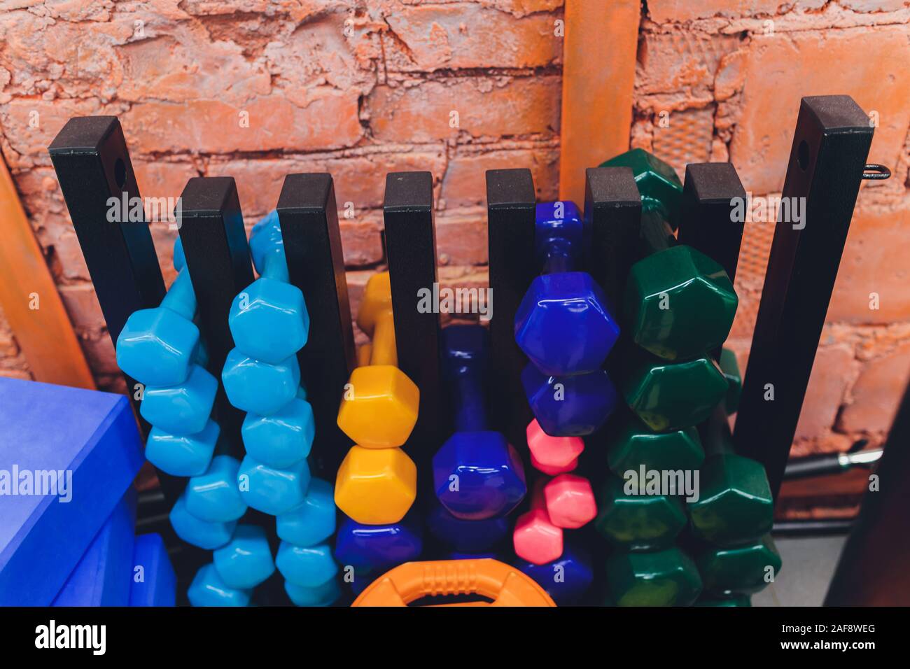 Receding row of weights lined up in a gym waiting for clients with ...