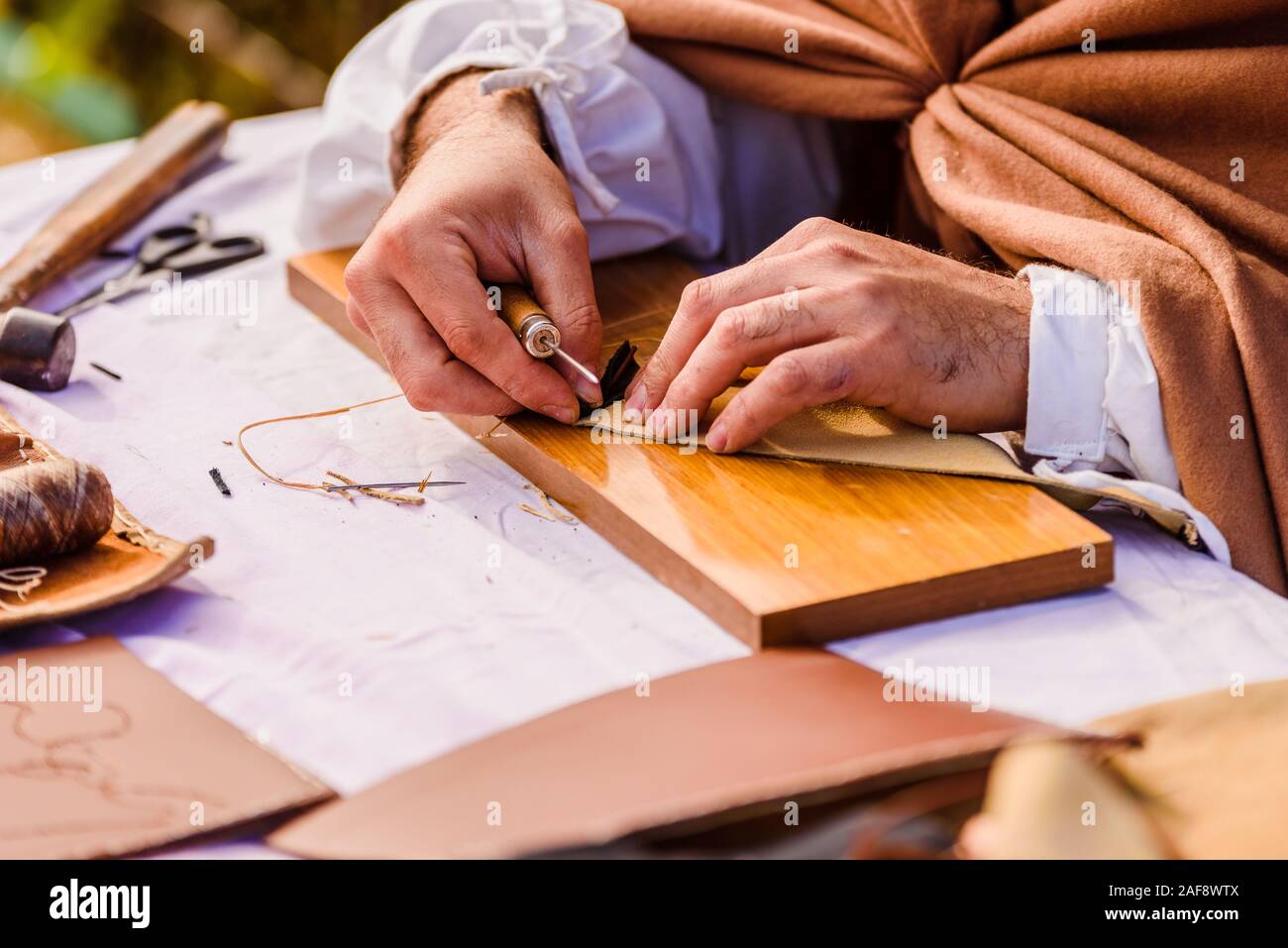 Artisans disguised in medieval times showing old crafts in a festival ...
