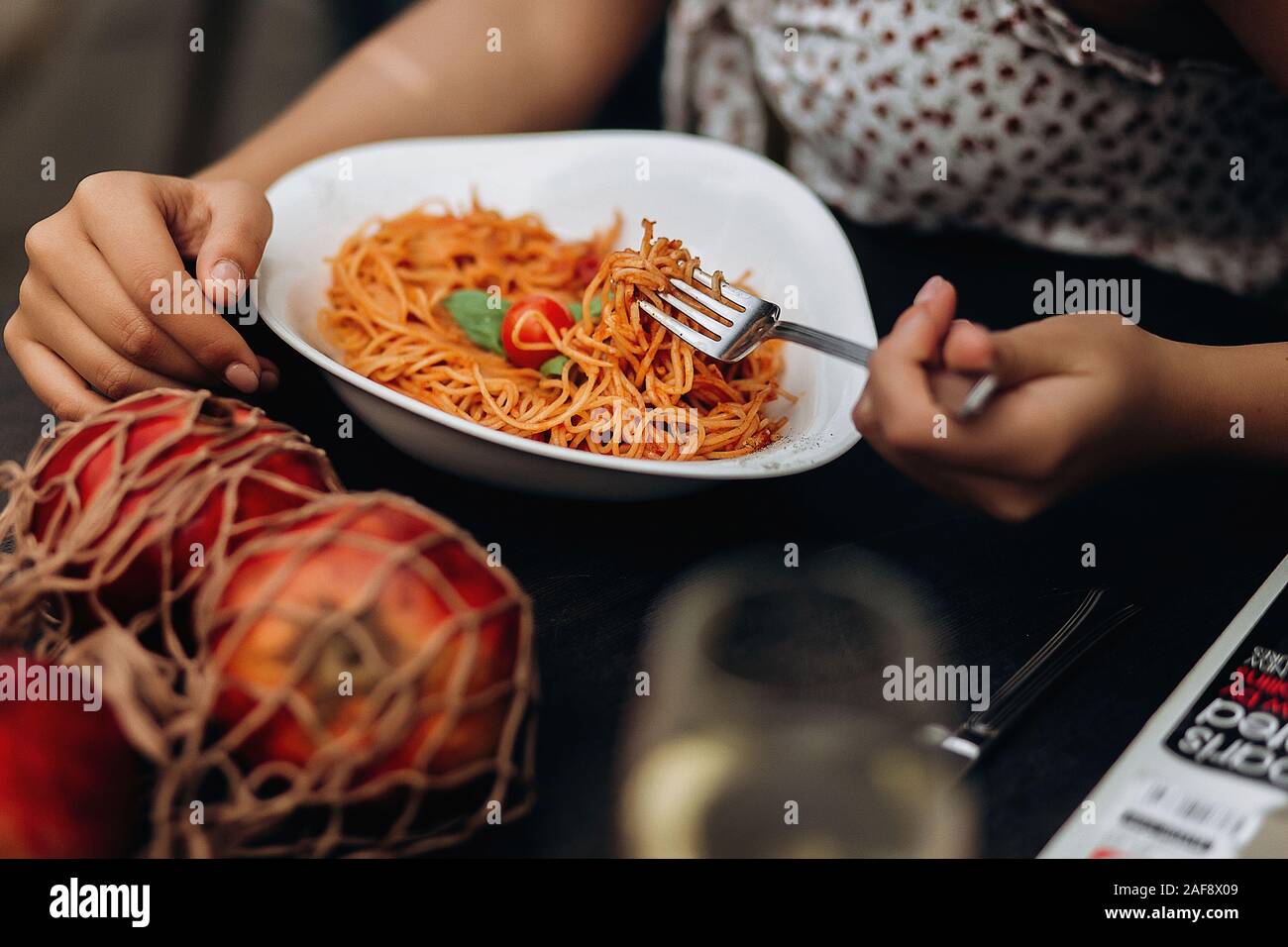 Beautiful smiling brunette girl having lunch in a street cafe, sitting ...