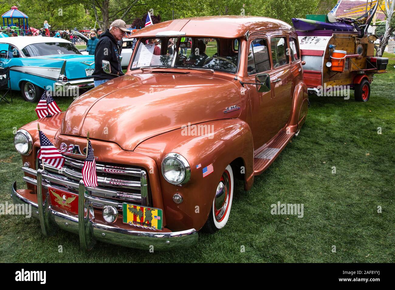 A restored and modified 1953 GMC Suburban with a custom camping trailer ...