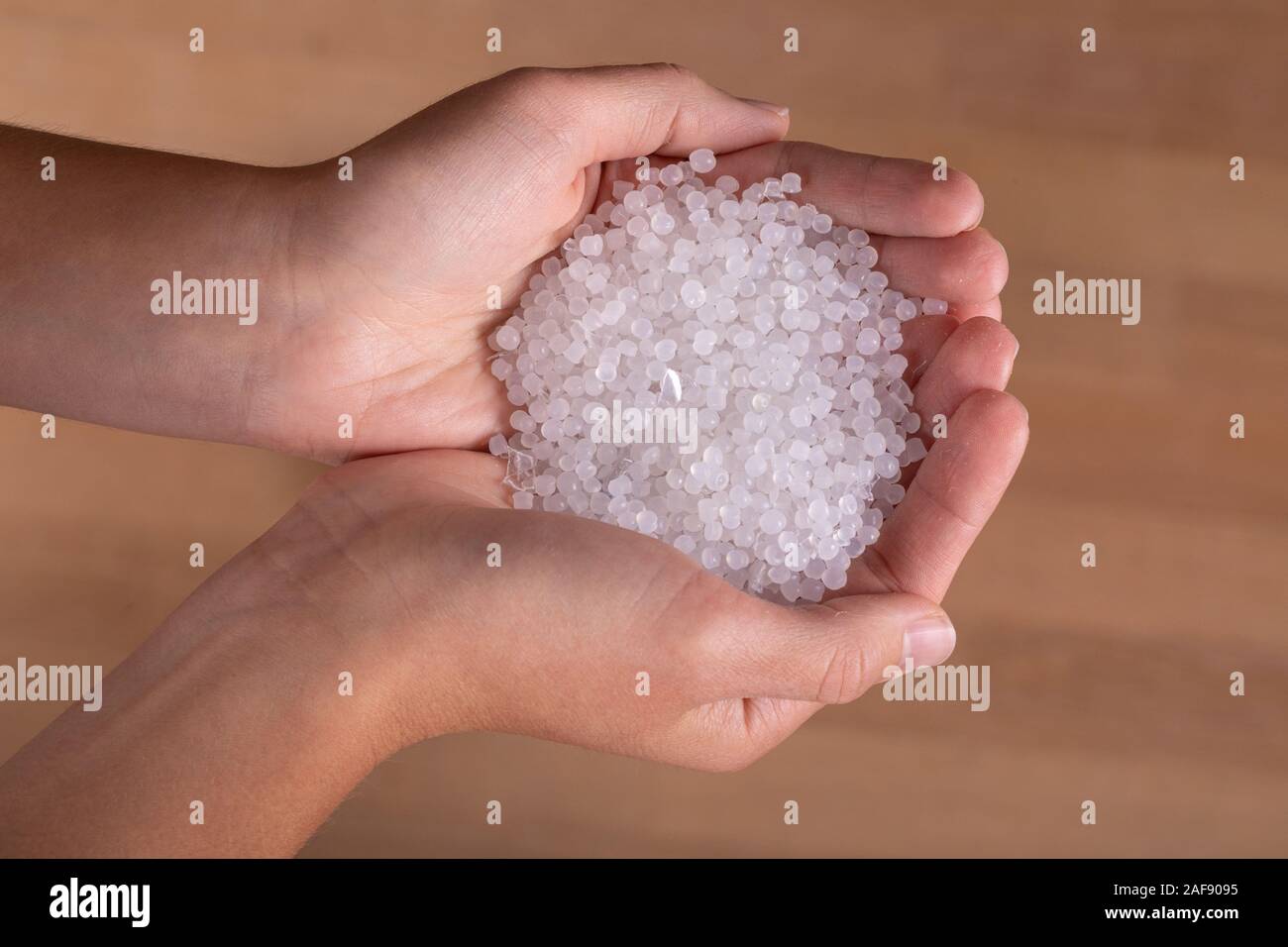 Small Plastic pellets on the finger.Micro plastic. air pollution Stock ...