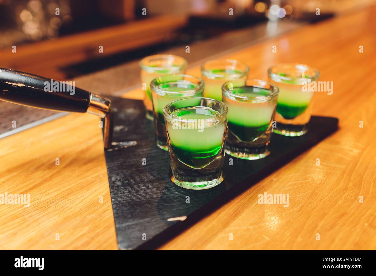 Barman make alcoholic shots with rum and liquor Stock Photo - Alamy