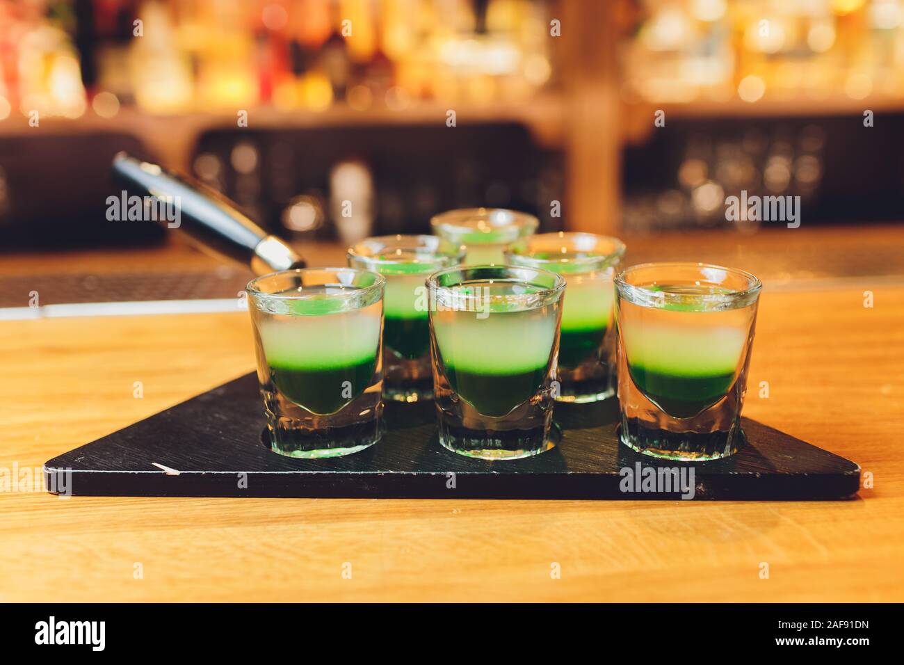 Barman make alcoholic shots with rum and liquor Stock Photo - Alamy