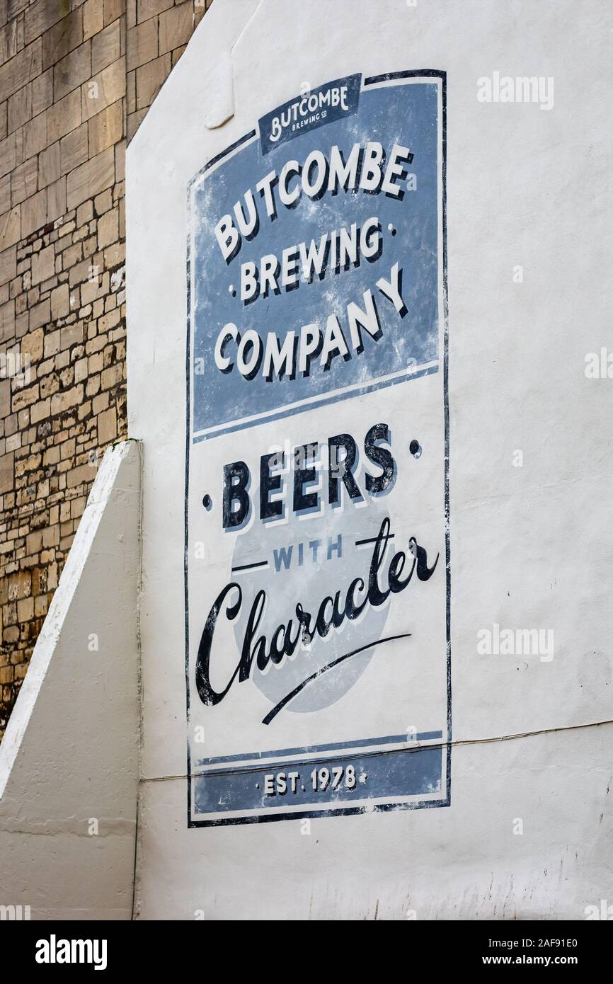 Advertising poster for Butcombe Beer painted on white Wall in Bath ...