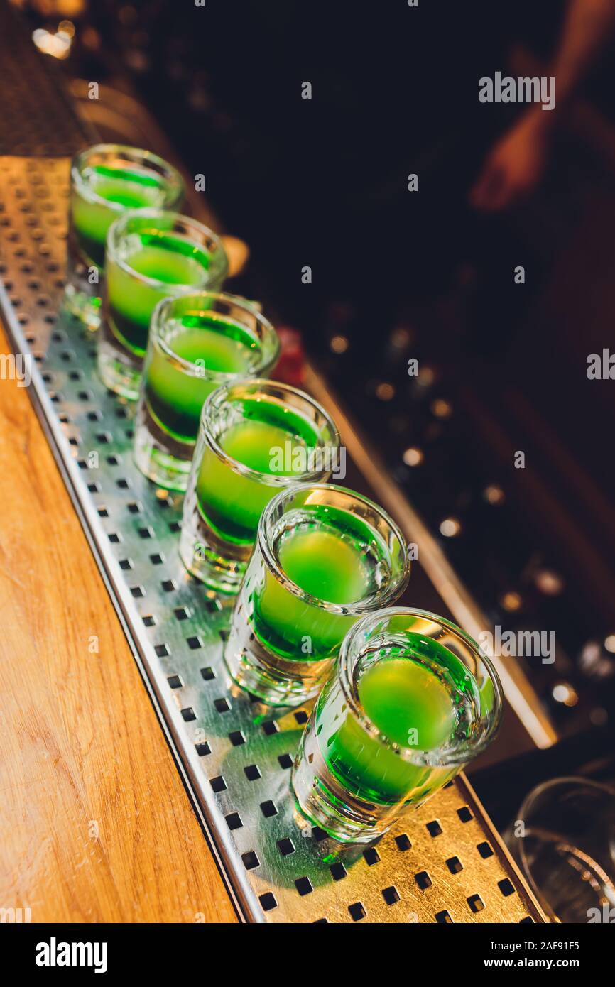 Barman make alcoholic shots with rum and liquor Stock Photo - Alamy