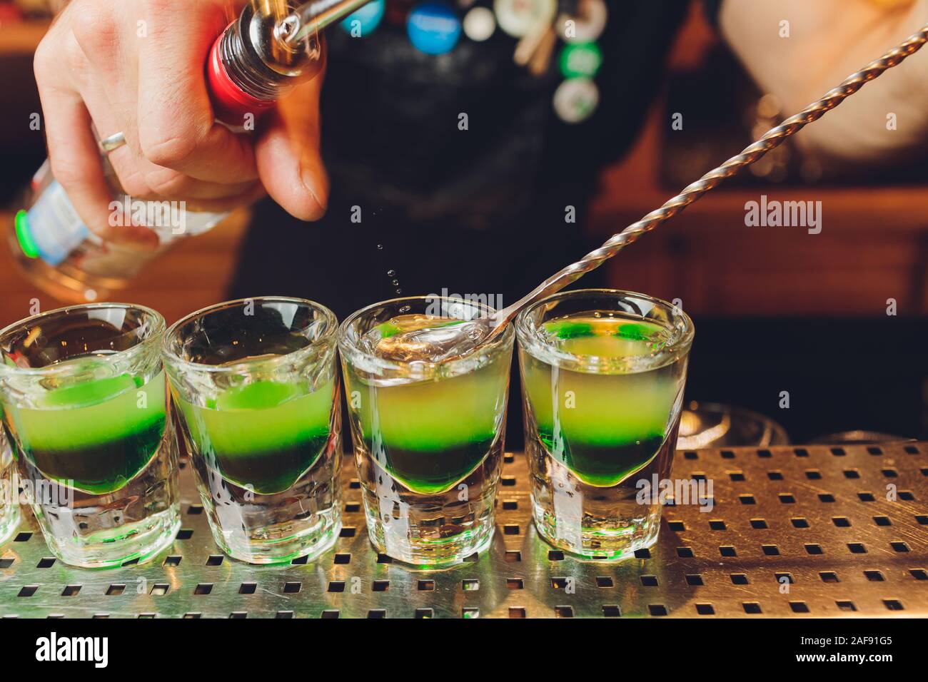 Barman make alcoholic shots with rum and liquor Stock Photo - Alamy
