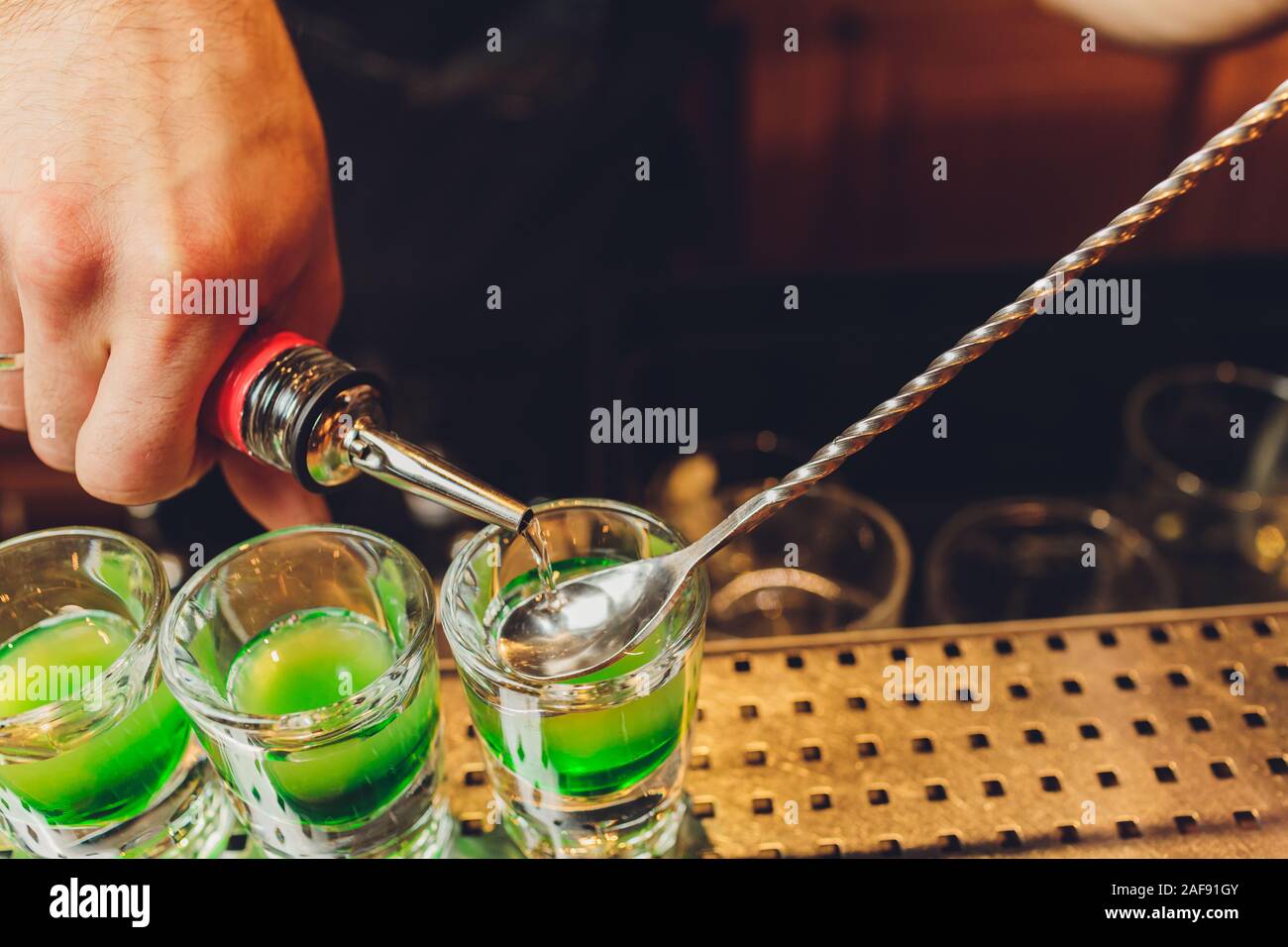 Barman make alcoholic shots with rum and liquor Stock Photo - Alamy