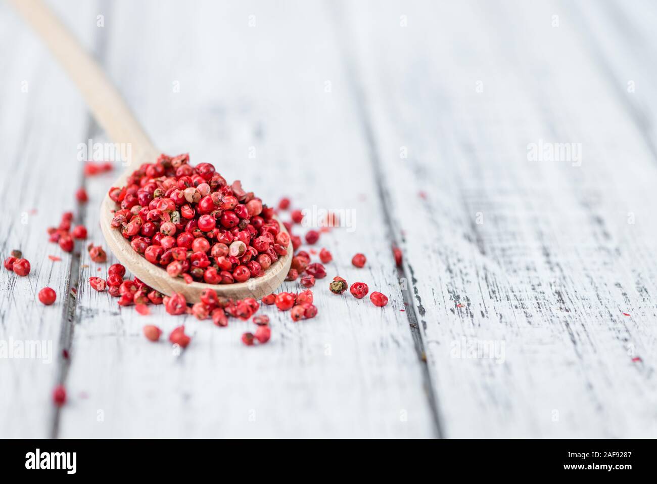 Pink Peppercorns on a vintage background as detailed close-up shot ...